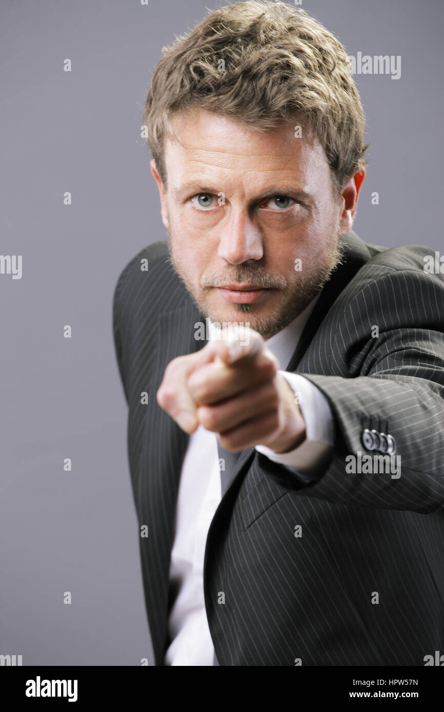Handsome businessman pointing towards the camera Stock Photo - Alamy