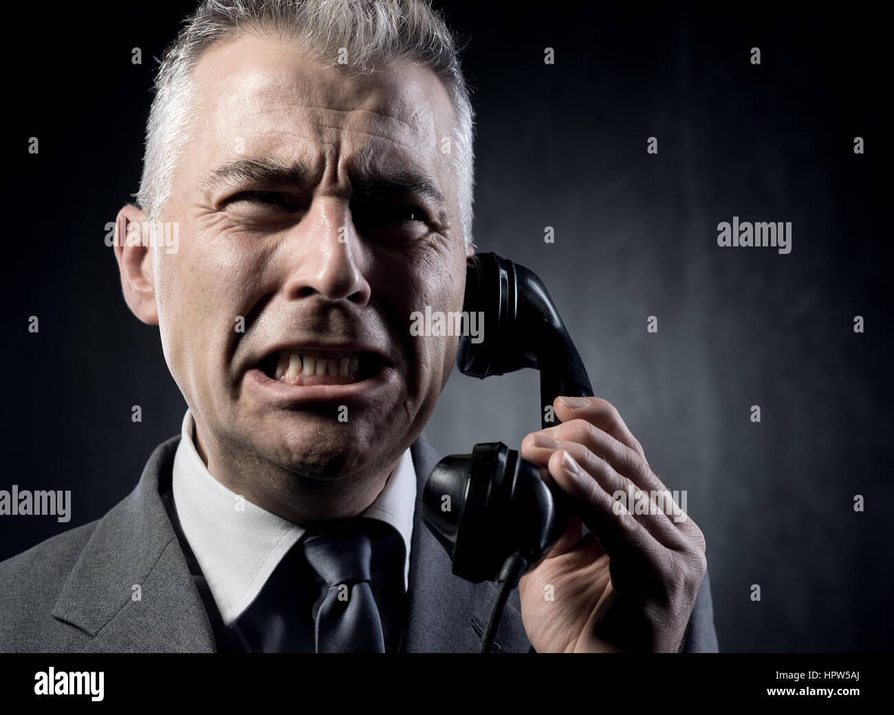 Handsome man holding a vintage phone receiver on dark background Stock ...