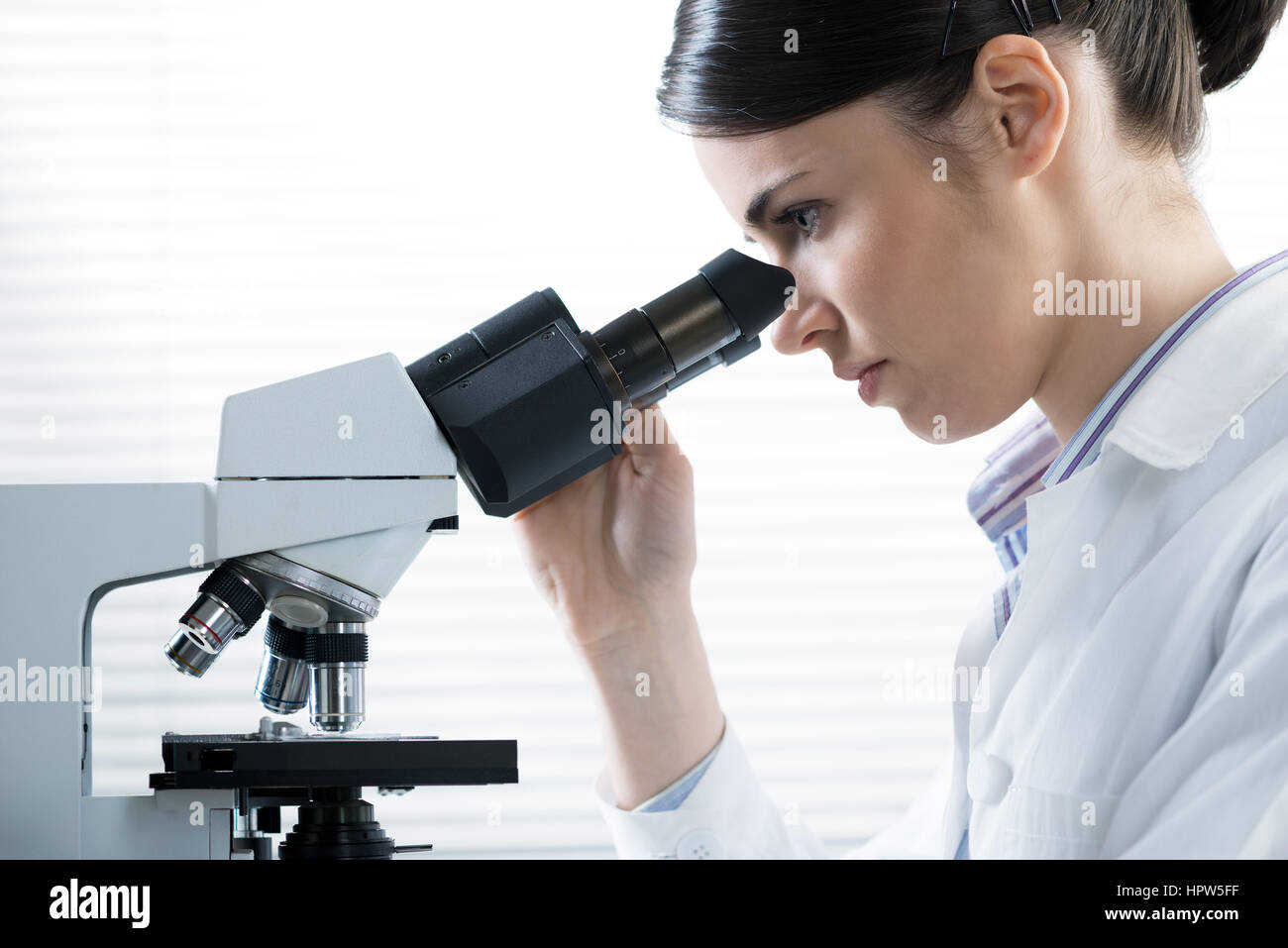 Scientist woman microscope examining samples hi-res stock photography and images - Alamy