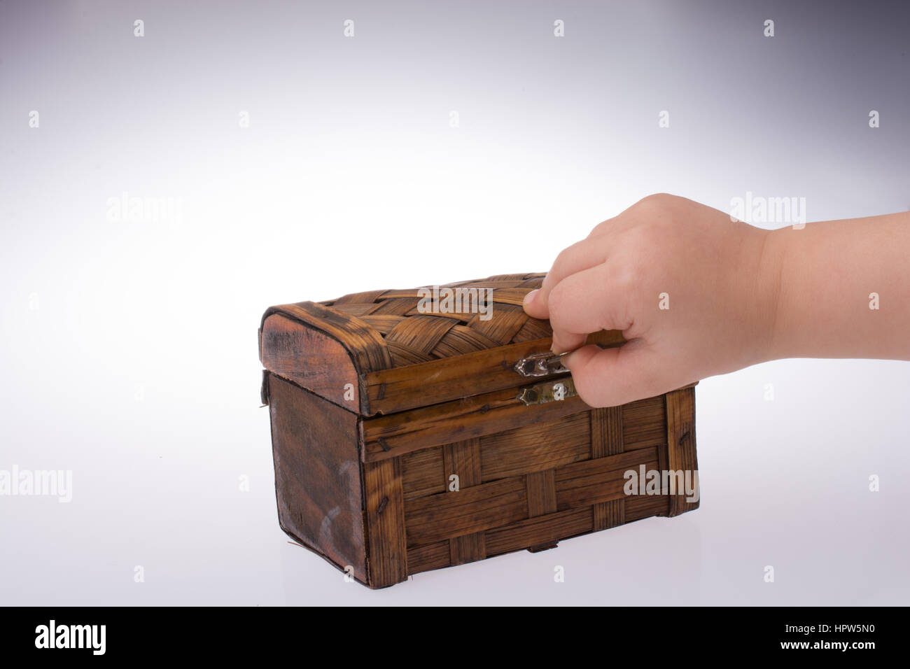 hand holding a brown wooden case on a white background Stock Photo - Alamy