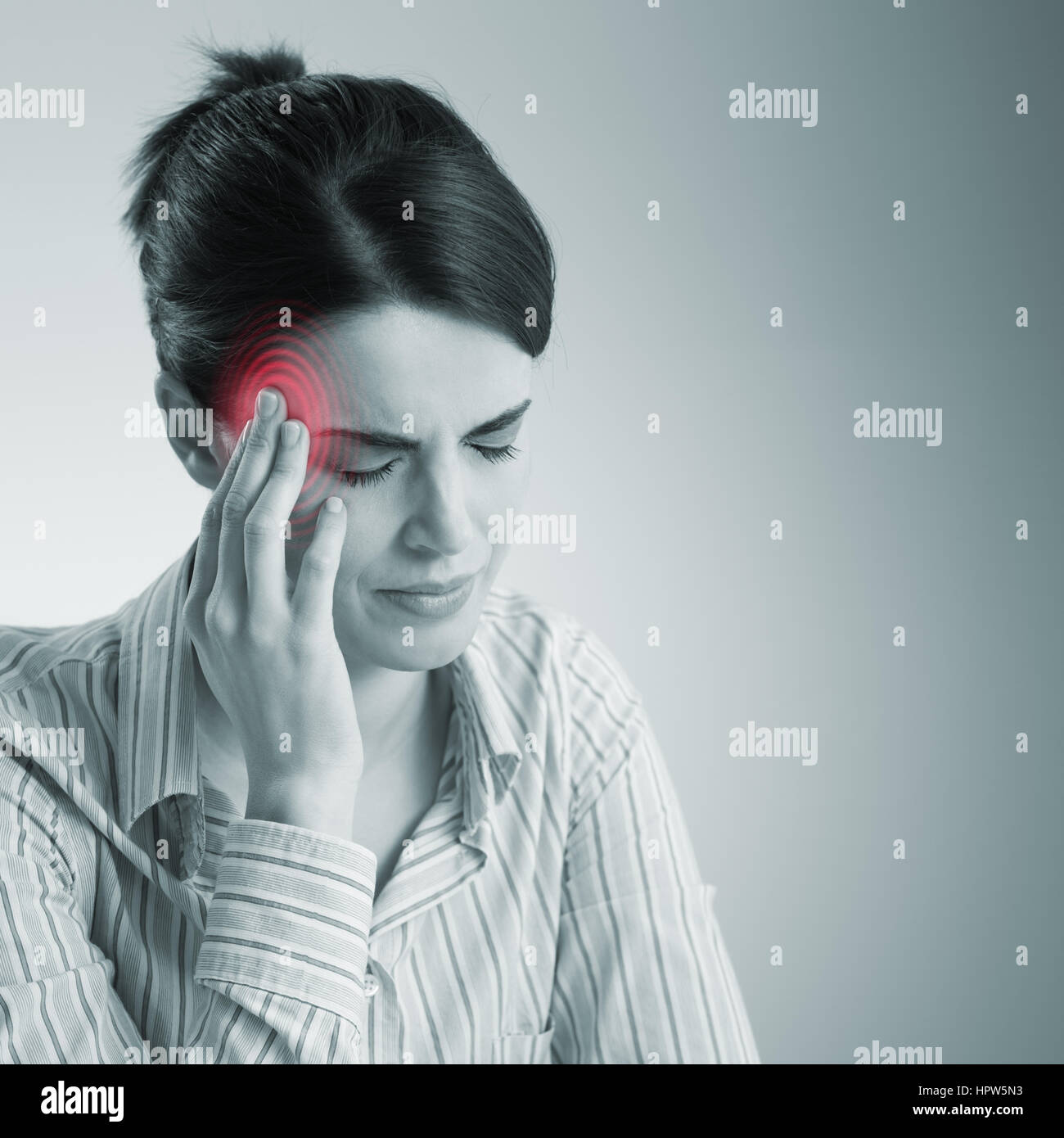 Young woman with headache touching her temples Stock Photo - Alamy