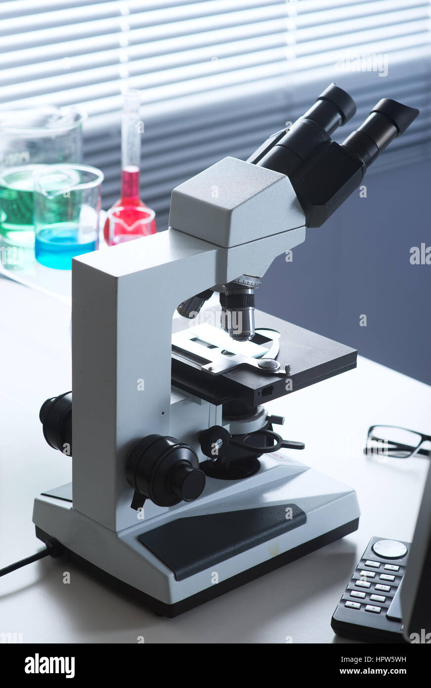 Microscope close-up and laboratory equipment on a desk Stock Photo - Alamy