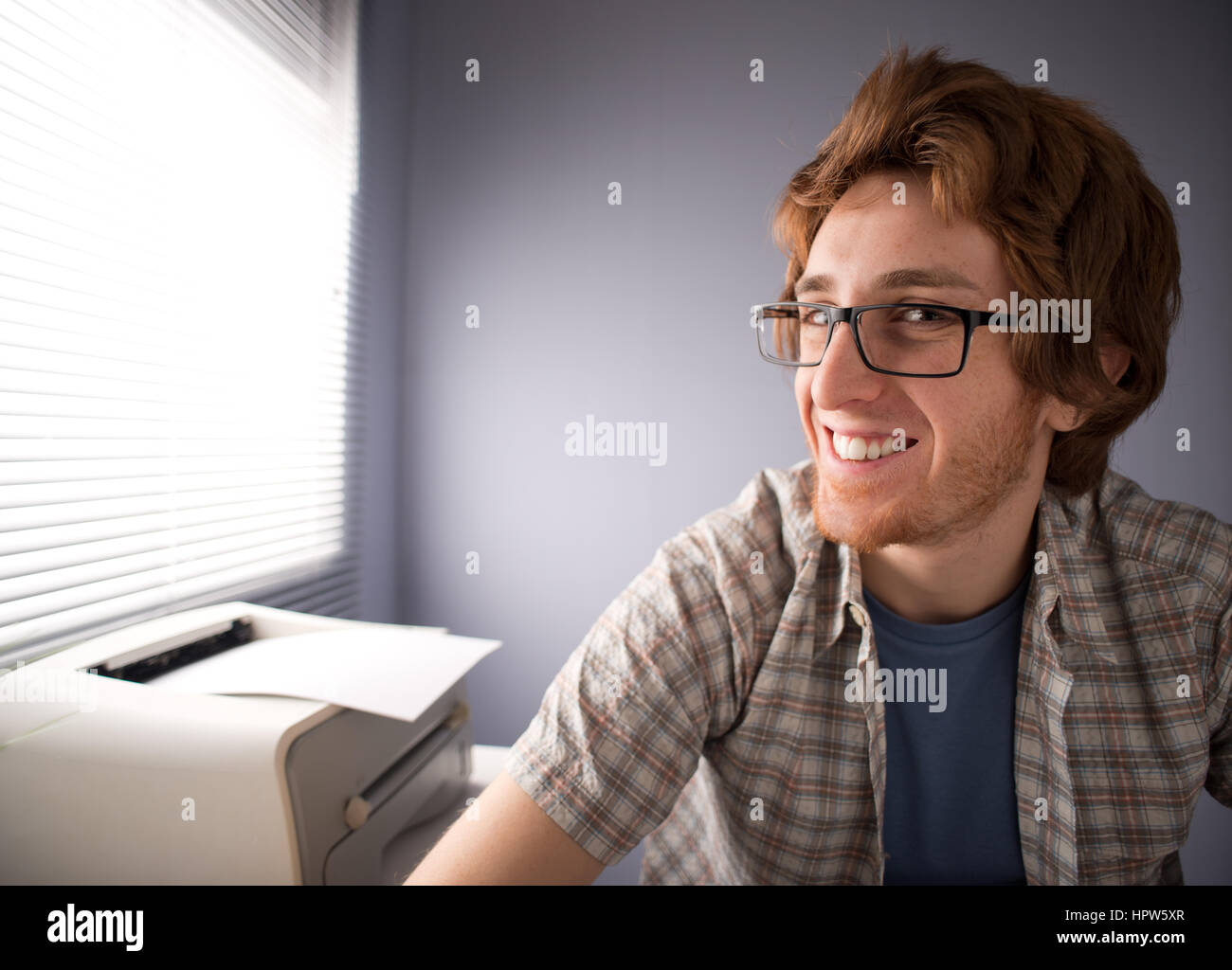 Funny nerd guy with glasses smiling, office on background Stock Photo ...