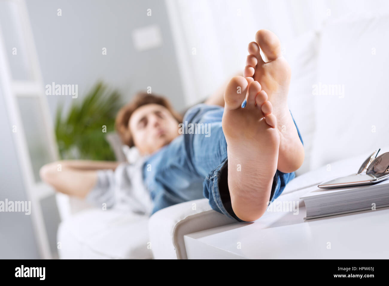 Man feet up sofa hi-res stock photography and images - Alamy