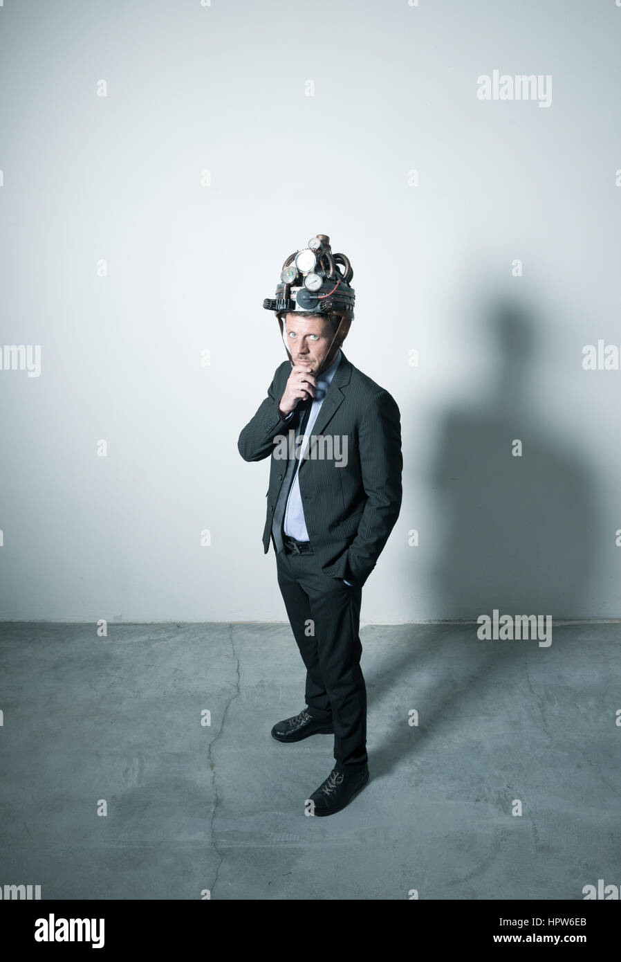 Confident businessman thinking with hand on chin wearing steampunk ...