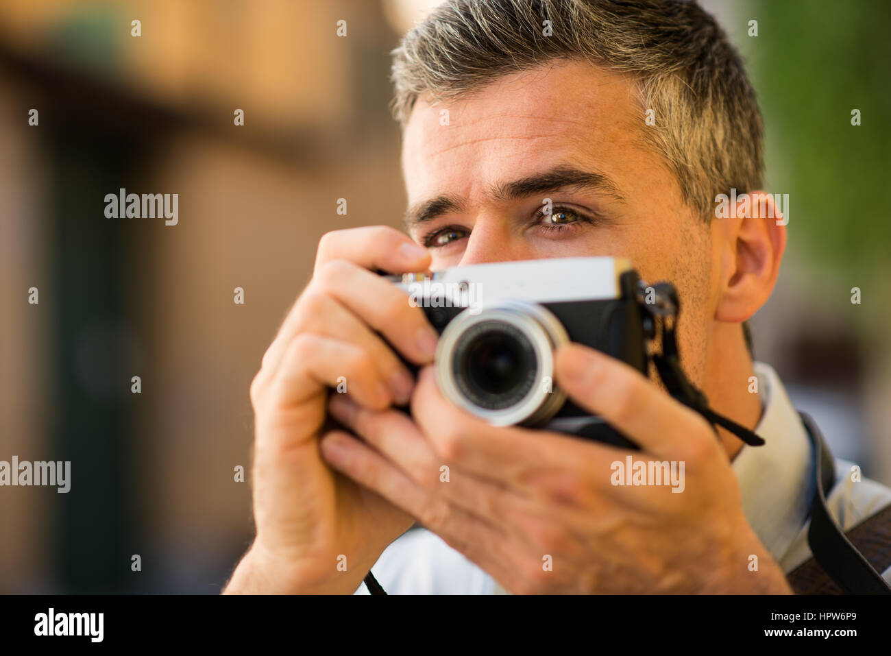Photographer shooting a picture with his digital camera, close up Stock ...