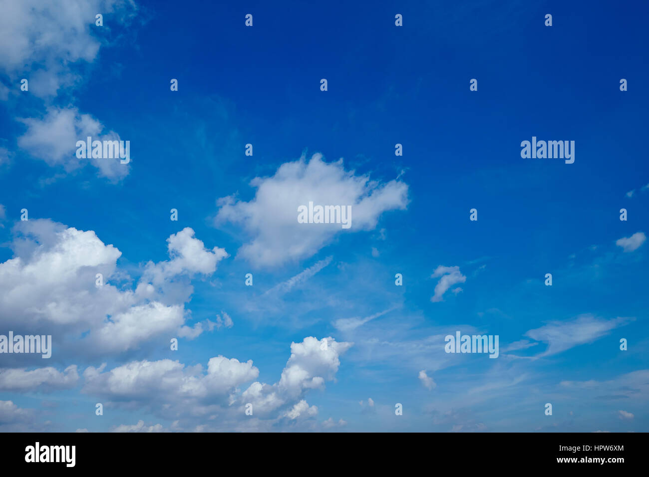 Wide blue sky with some white clouds Stock Photo - Alamy
