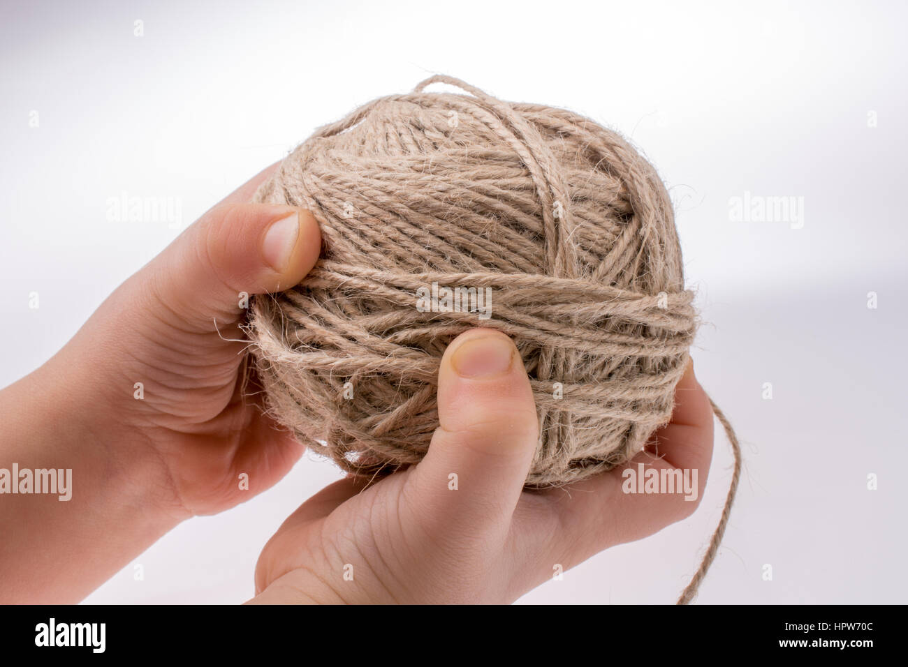 Spools of thread in hand isolated on a white background Stock Photo - Alamy