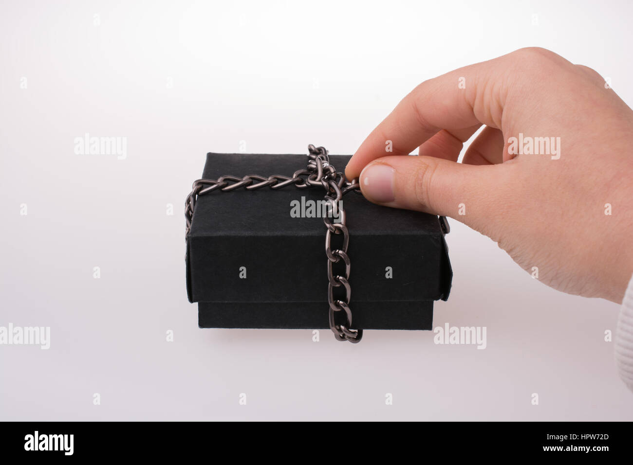 Hand holding a gift box of black color in hand Stock Photo - Alamy