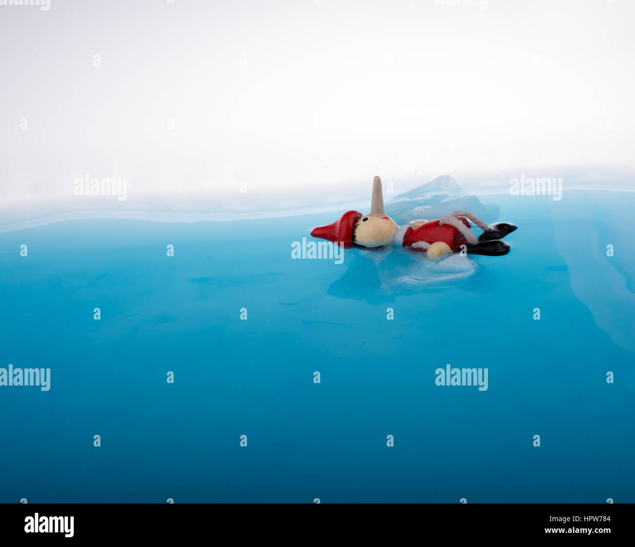 Wodden puppet Pinocchio on in blue water Stock Photo - Alamy