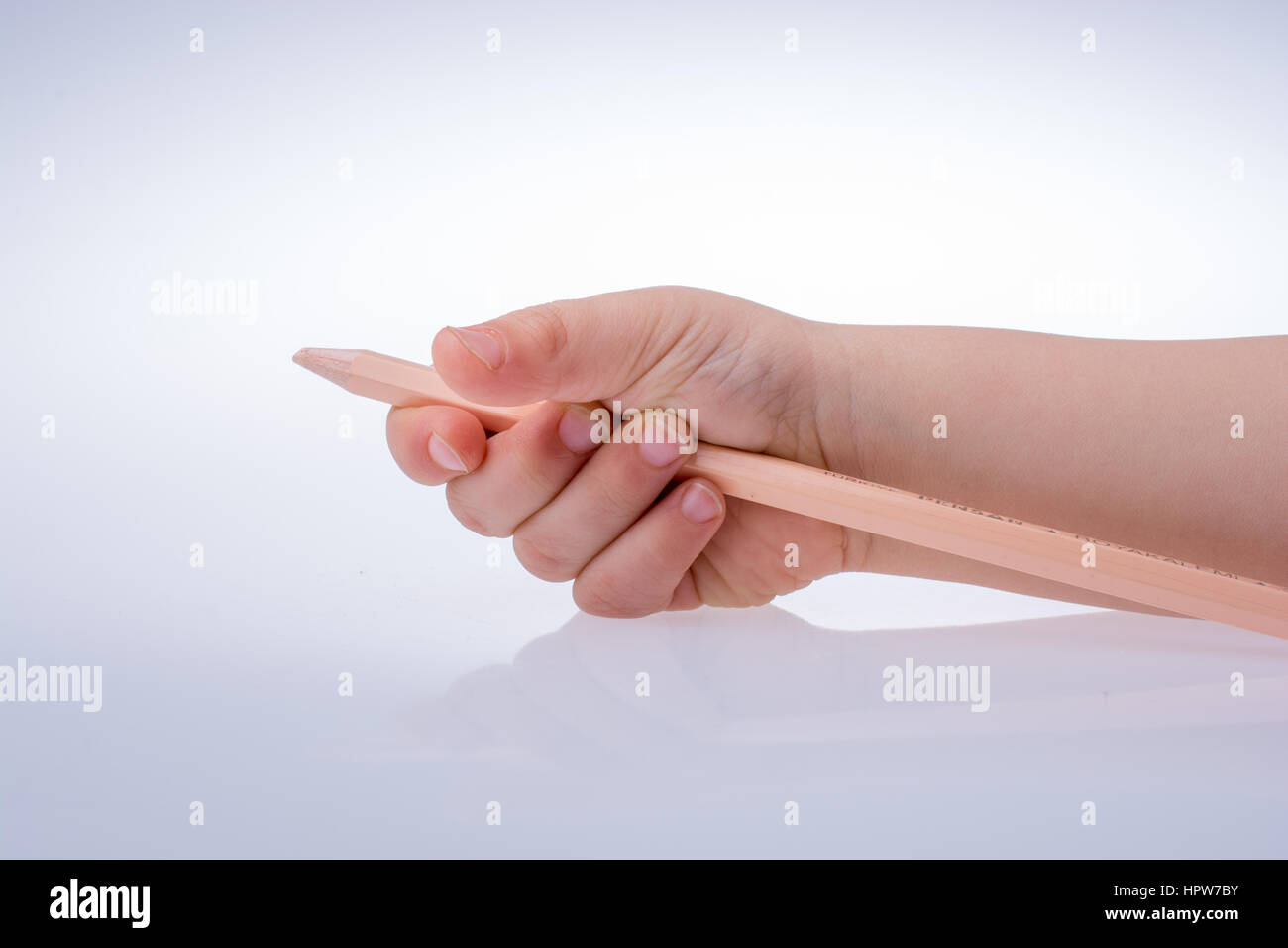 Hand holding a color pencil on a white background Stock Photo - Alamy