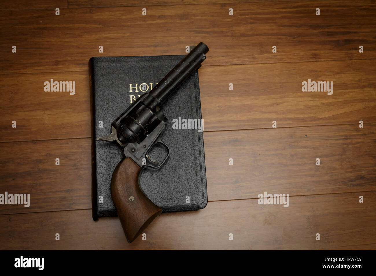 revolver on black bible Stock Photo - Alamy