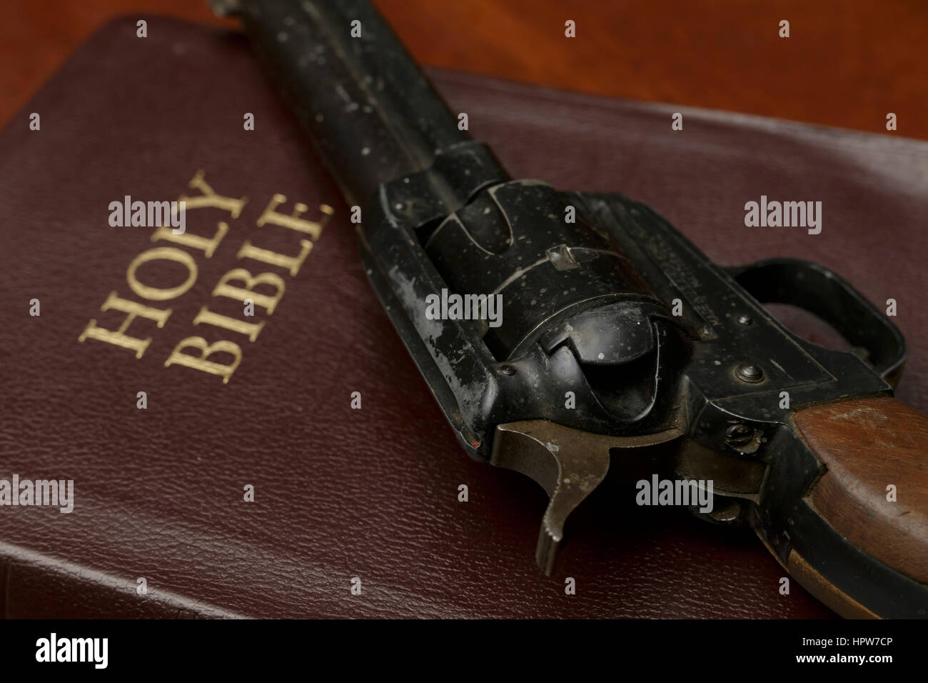 a revolver on a bible Stock Photo - Alamy