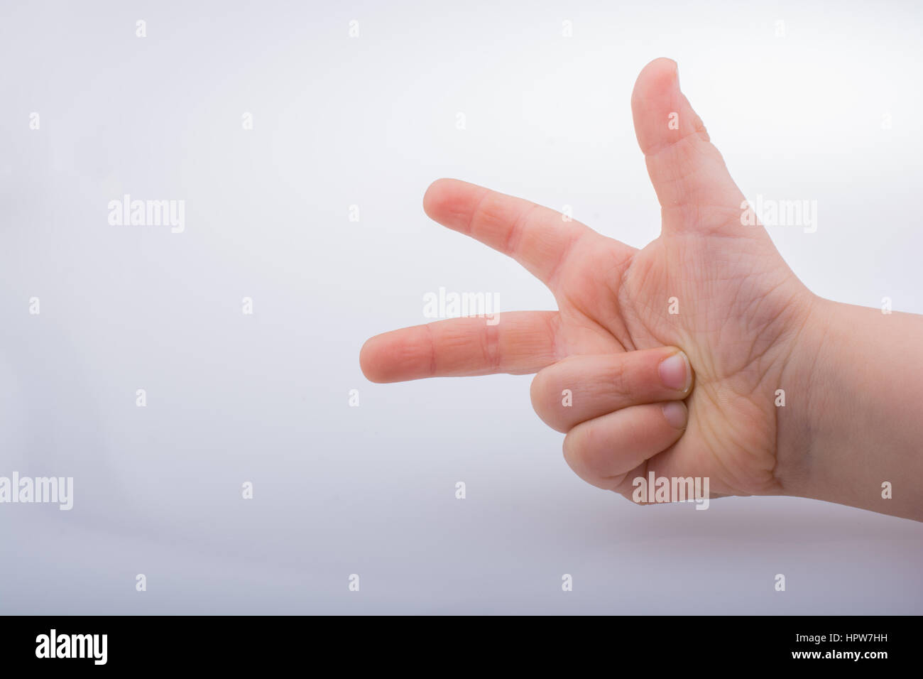 Kid's hand making a number three gesture Stock Photo - Alamy