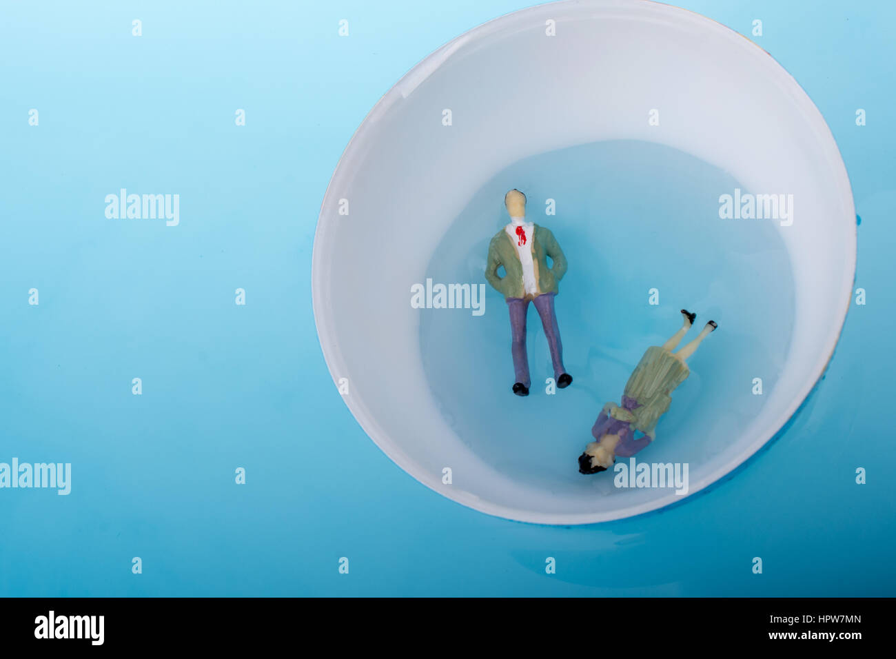 Little model globe with figurines floating in blue water Stock Photo ...