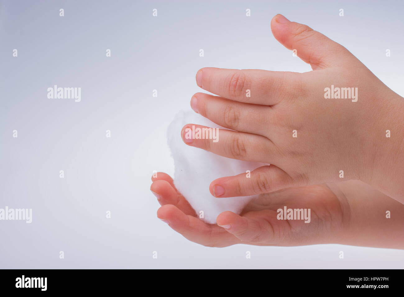 Hand holding some cotton in hand on a white background Stock Photo - Alamy