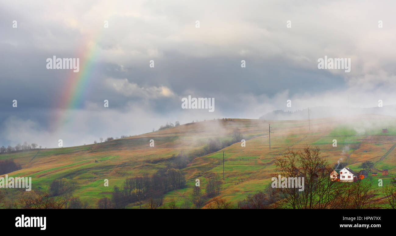 Rainbow in the sky with foggy alpine morning Stock Photo - Alamy
