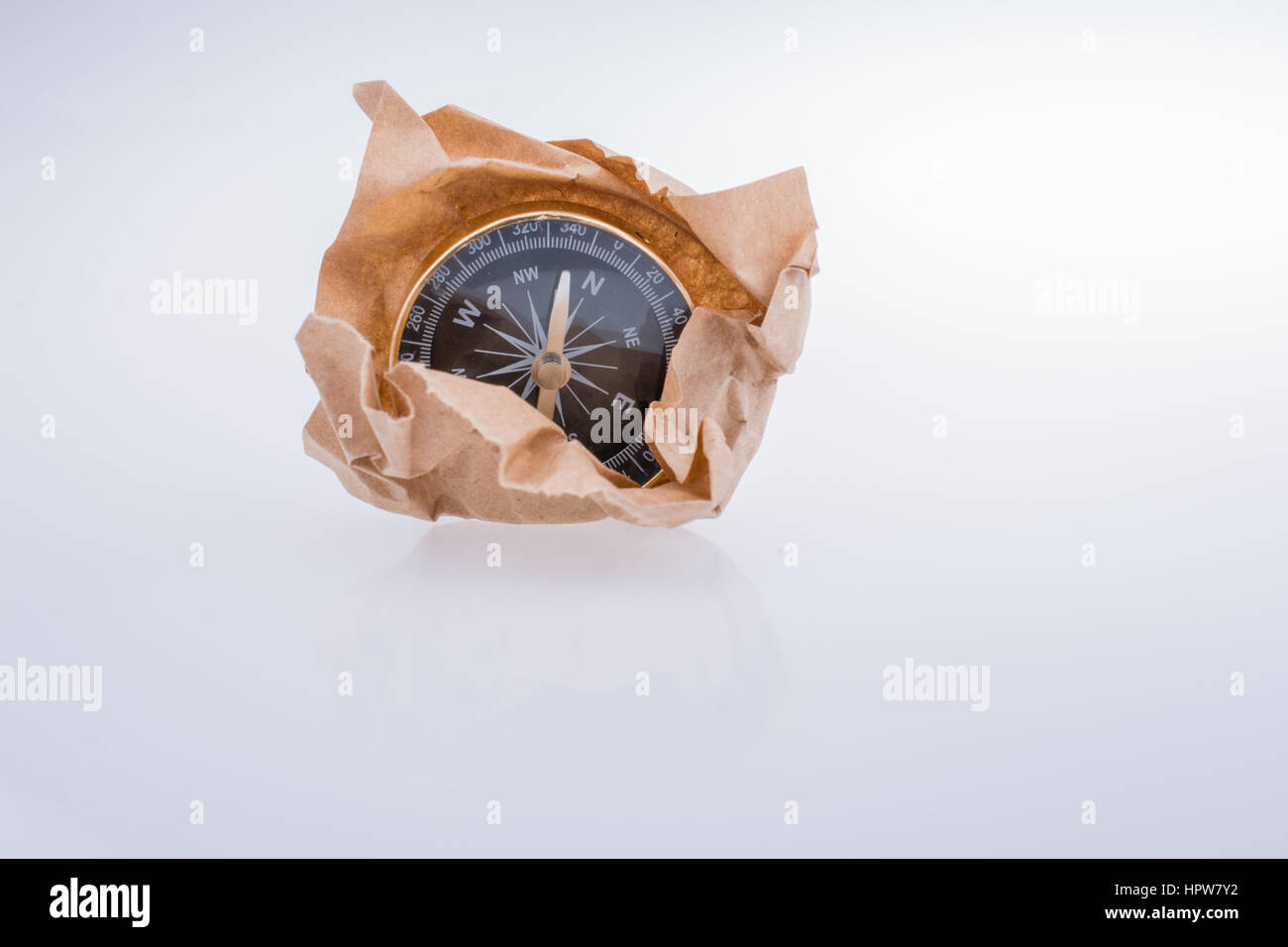Black compass instrument wrapped in brown paper Stock Photo - Alamy