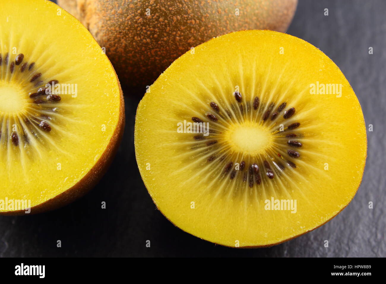 composition of fresh yellow kiwi fruits on a slate plate Stock Photo ...
