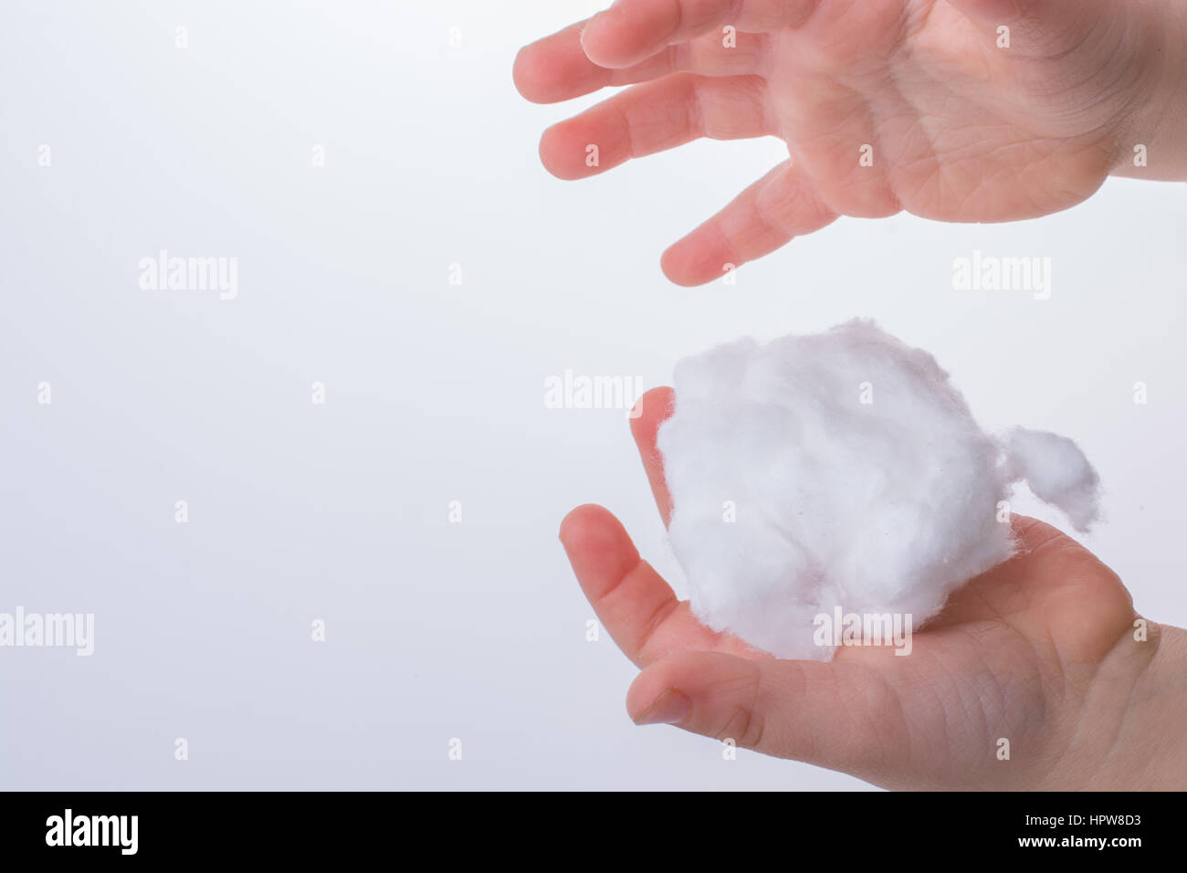 Hand holding some cotton in hand on a white background Stock Photo - Alamy