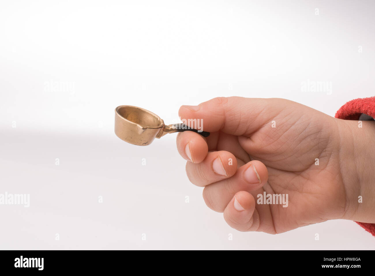 Hand holding a little model pan as a kitchen utensil Stock Photo - Alamy