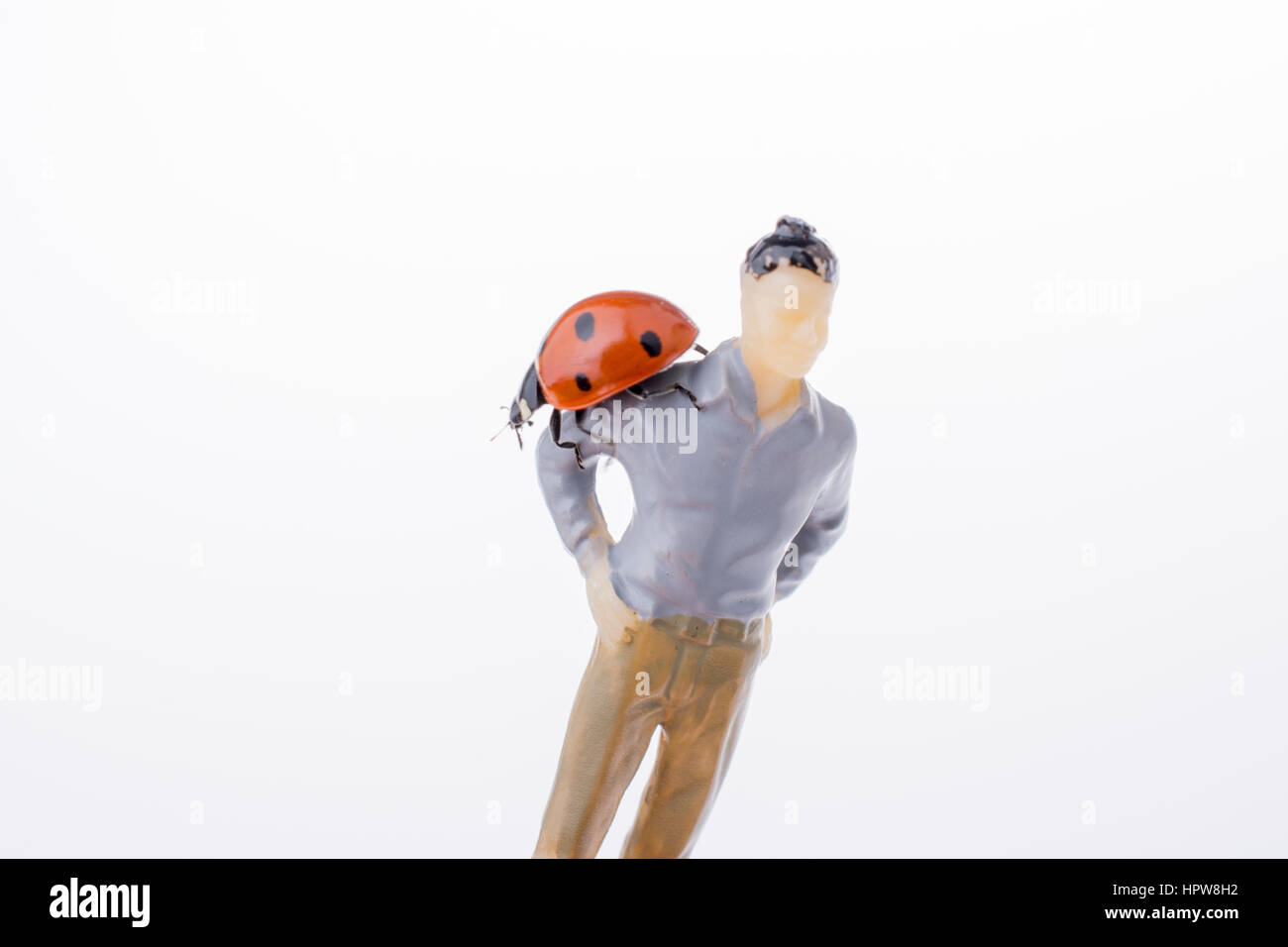 Ladybug walking on body of figurine man Stock Photo - Alamy