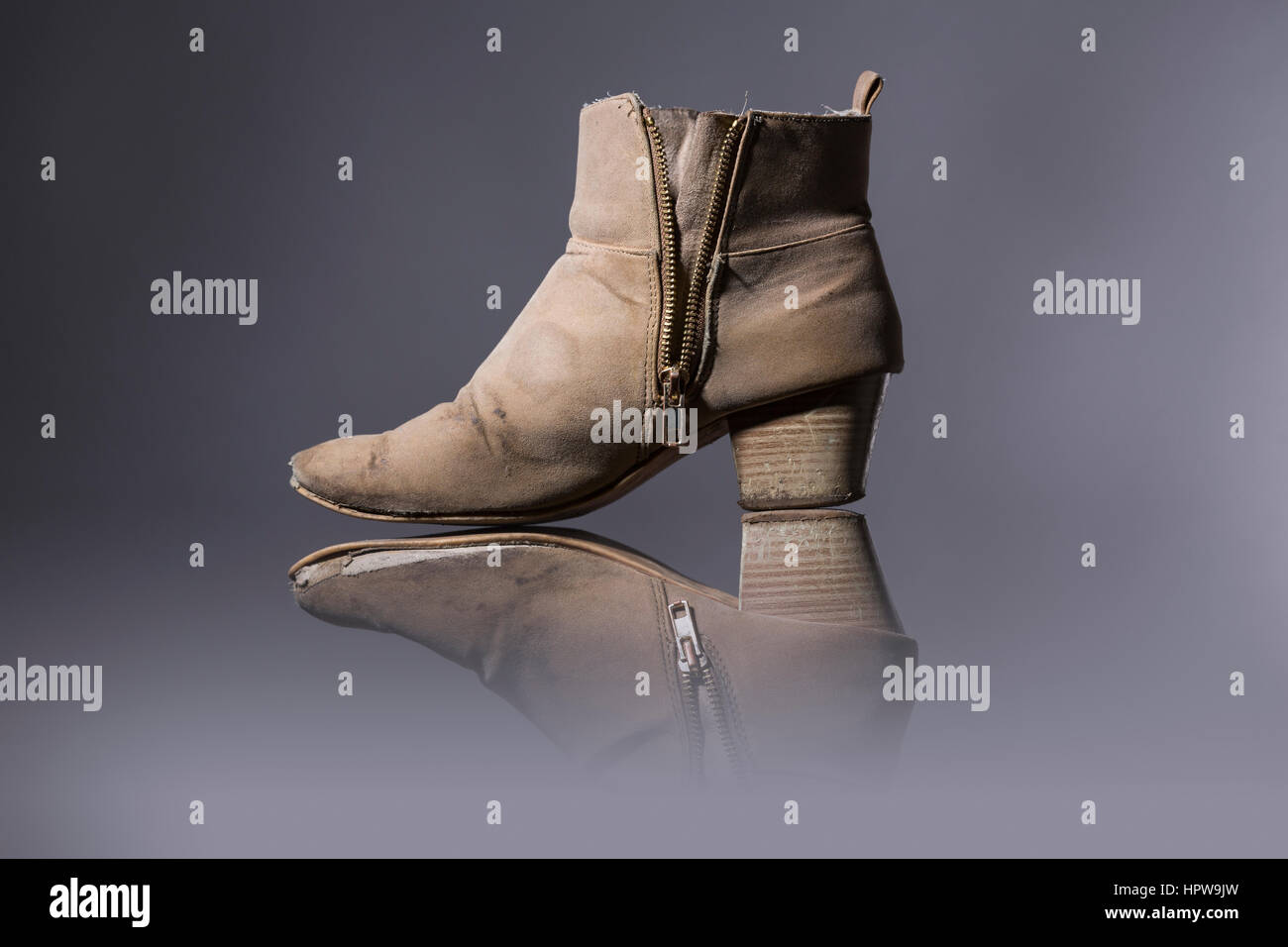 old, damaged female shoes with gray background Stock Photo - Alamy