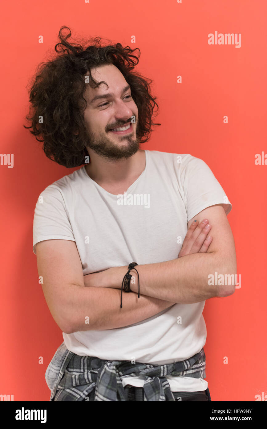 Portrait of a beautiful young man with funny hair over color background ...
