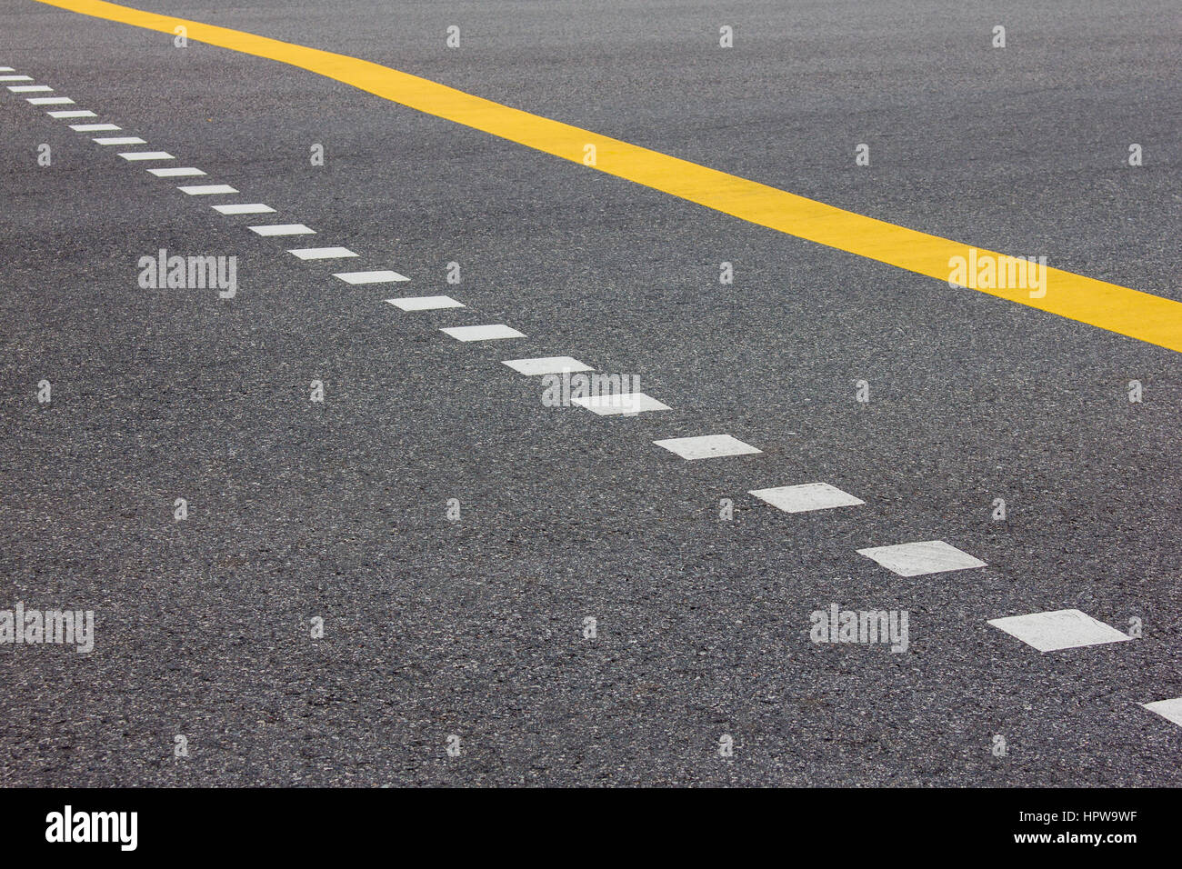 Asphalt road texture background with yellow line Stock Photo - Alamy