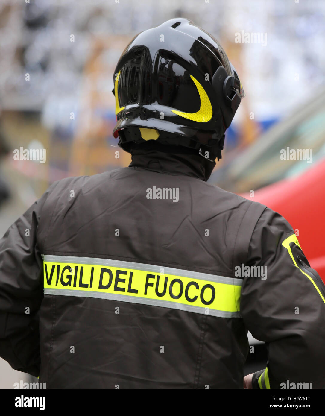 Italian firefighter with protective helmet and the word VIGILI DEL ...