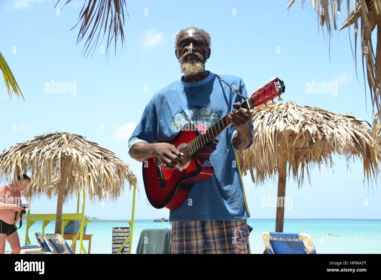 Sandy beach, coast in Negril, Jamaica, Caribbean. Native at tourists ...