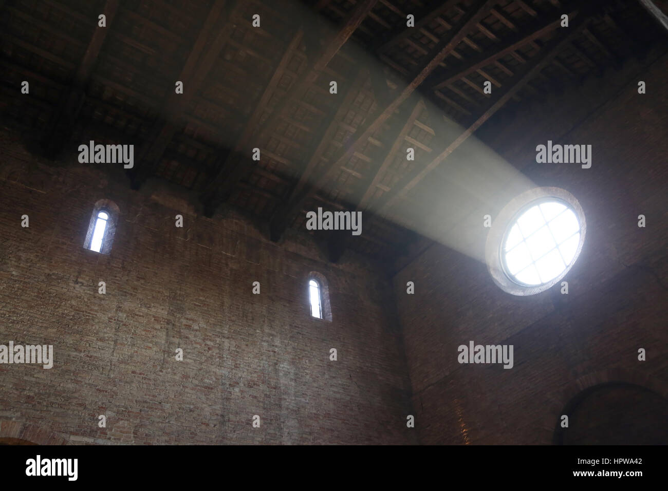 atmospheric beam of light coming from the rose window in ancient ...
