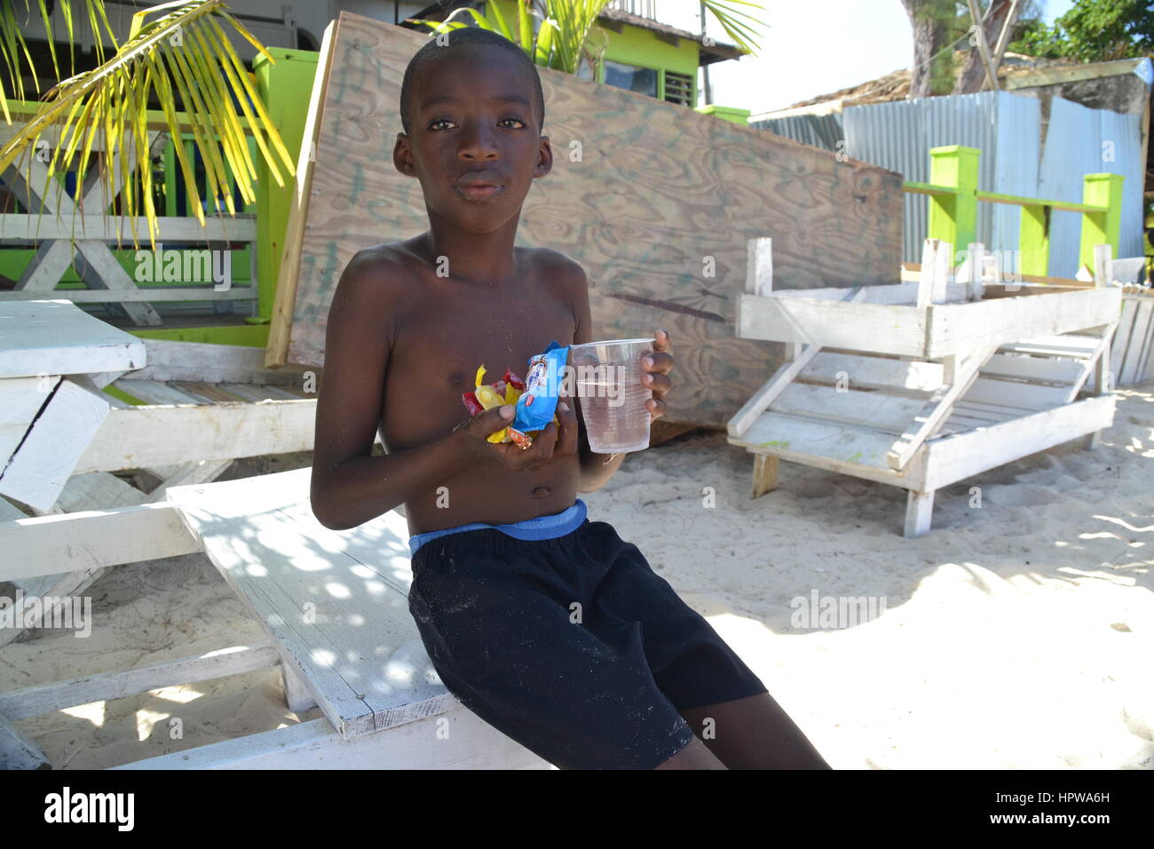 Sandy beach, coast in Negril, Jamaica, Caribbean. Native at tourists, cute young boy Stock Photo ...