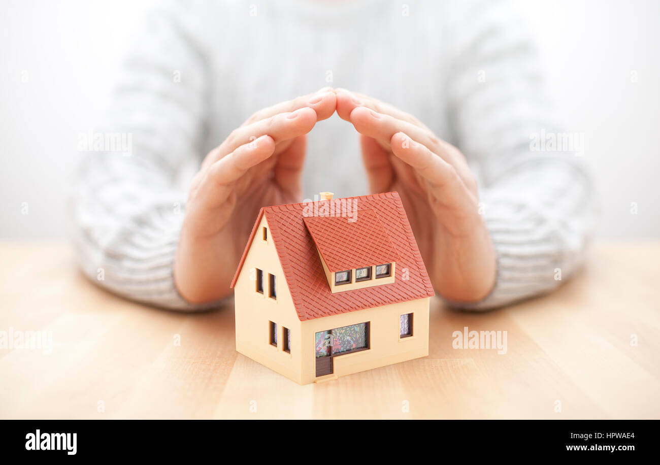 Hands protecting house hi-res stock photography and images - Alamy