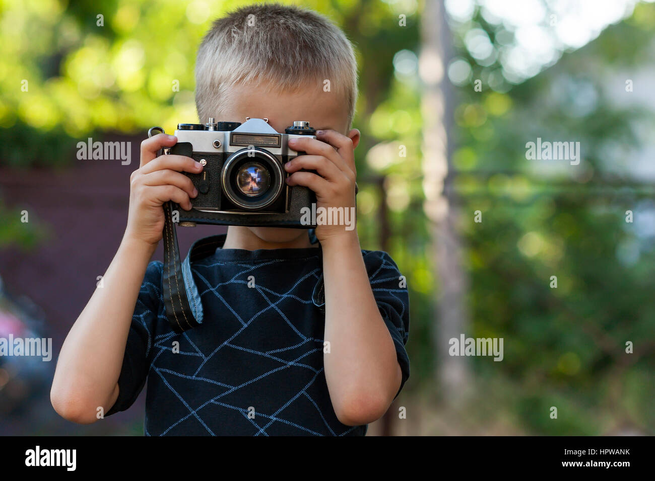 Cute little happy boy with vintage photo camera outdoors Stock Photo ...