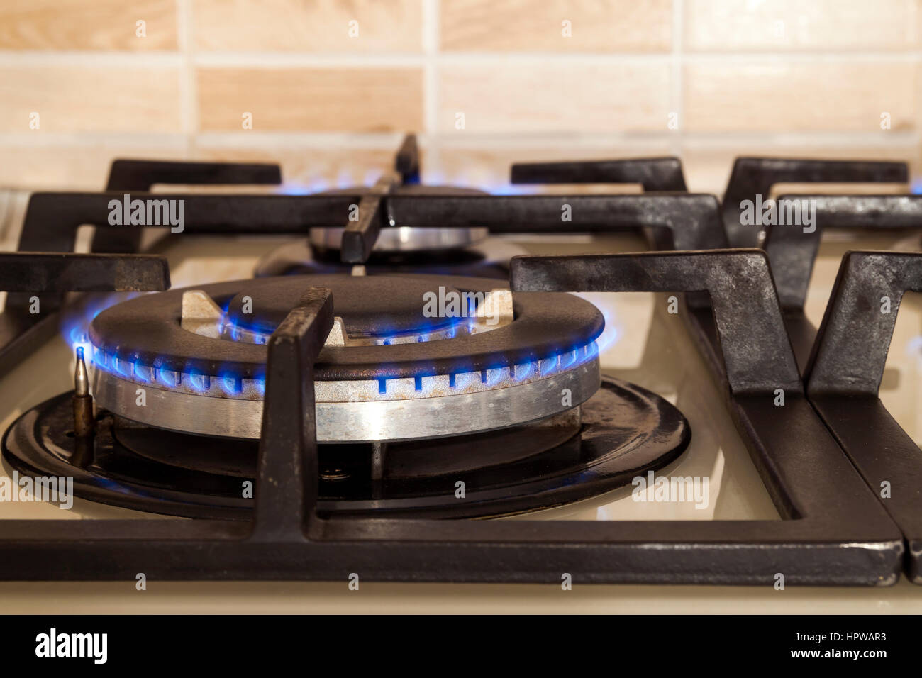 Closeup shot of blue fire from domestic kitchen stove. Gas cooker with ...
