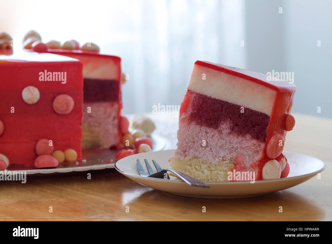 Homemade red birthday cake with air baloons. Slice of a red velvet cake ...