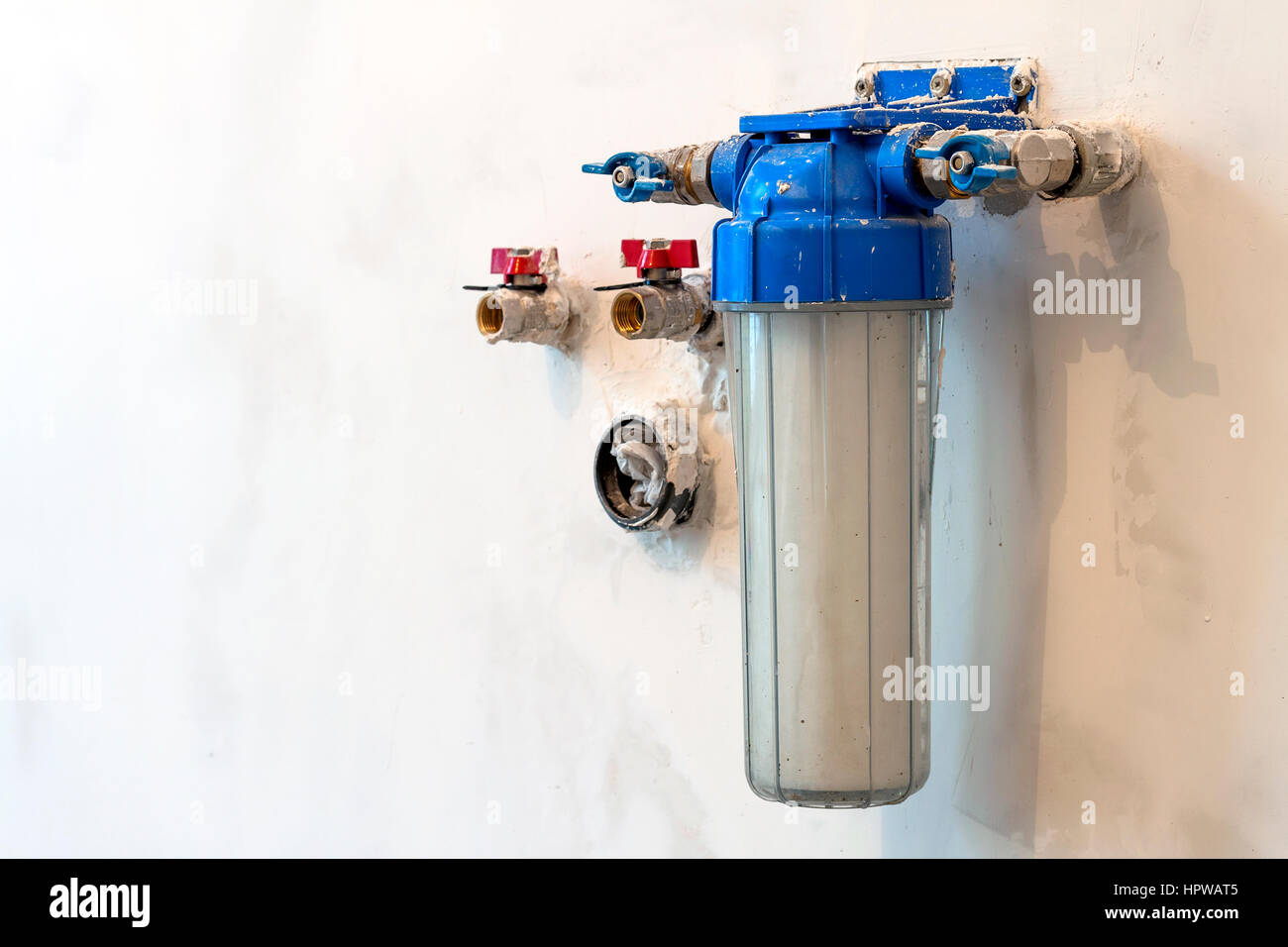 Water filter new installed on a kitchen wall to purify drinking water ...
