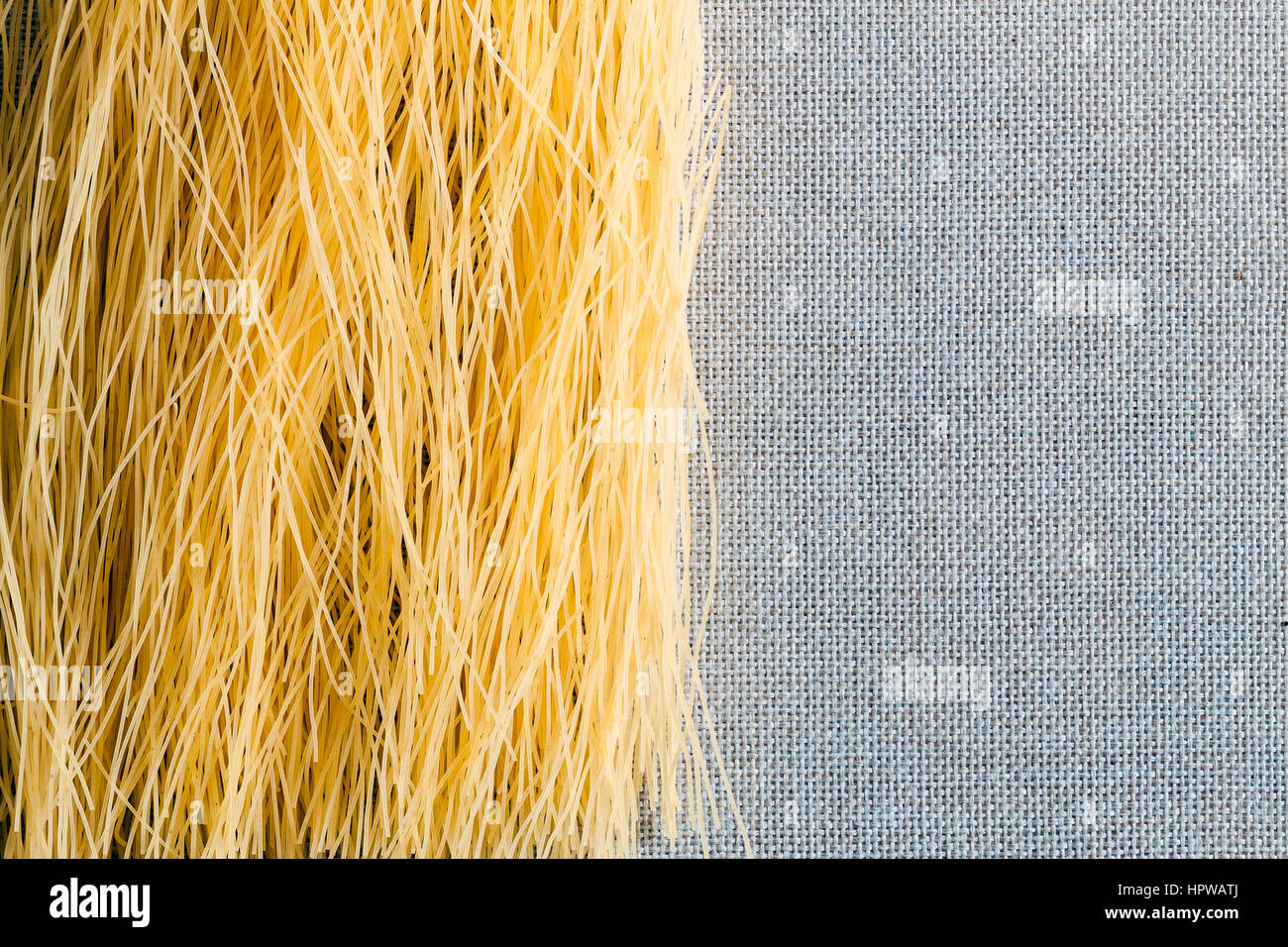 Bavette pasta spaghetti on a burlap cloth with a dark background with ...