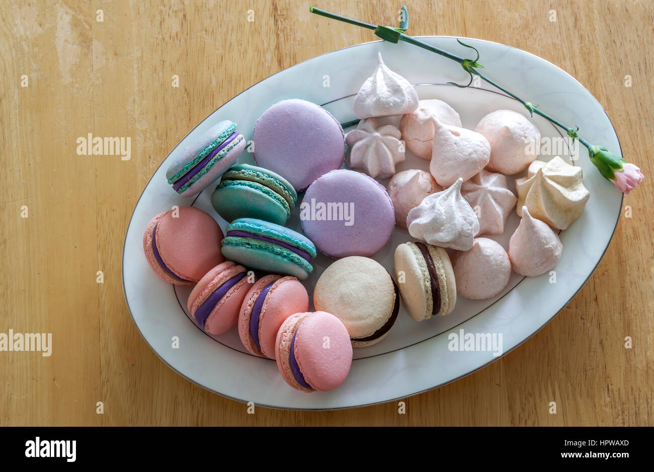Sweet and colorful french macaroons or macaron in ceramic white plate ...