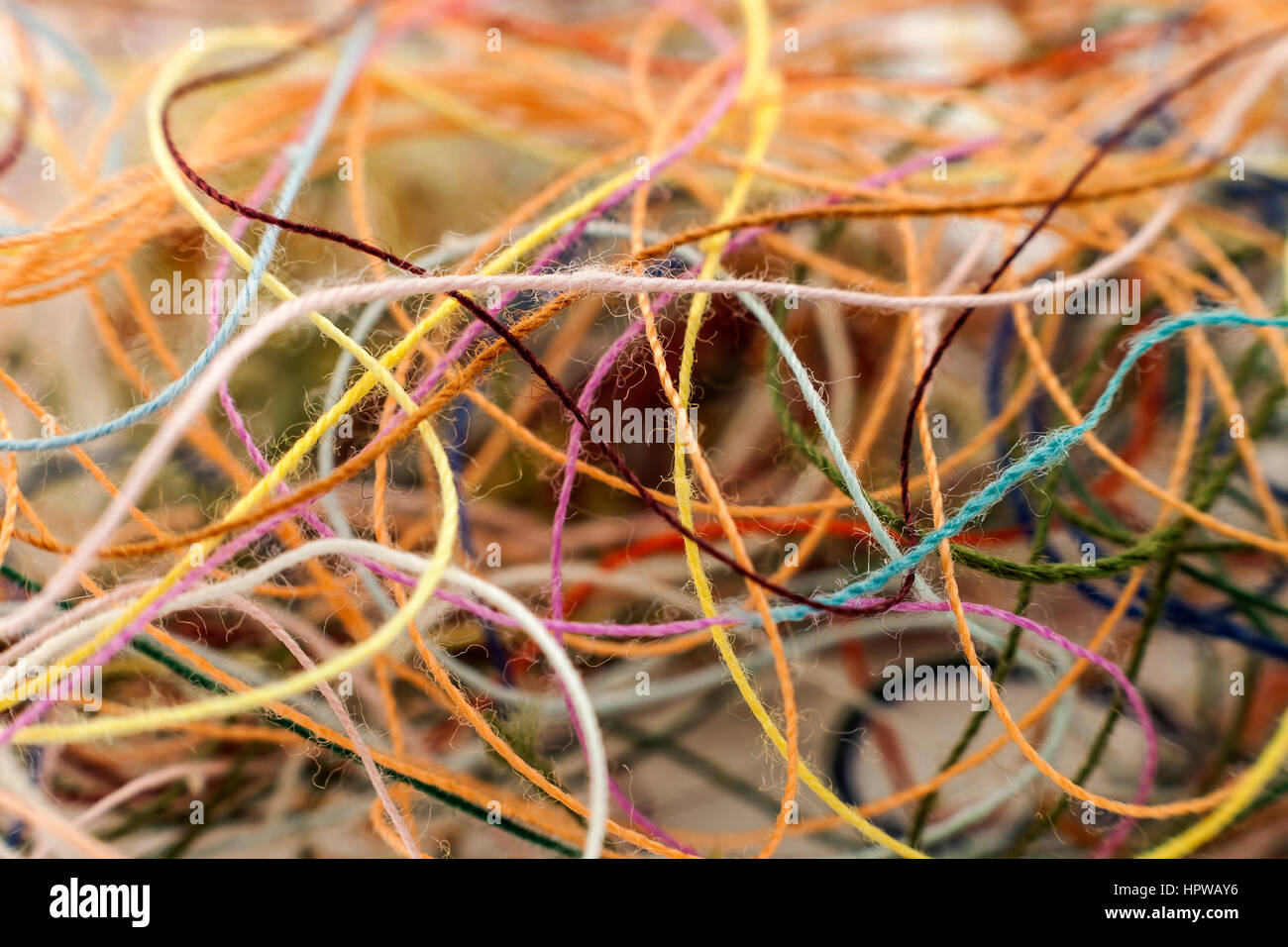 Multi-colored tangled colorful needlecraft silk thread rope. Macro shot ...