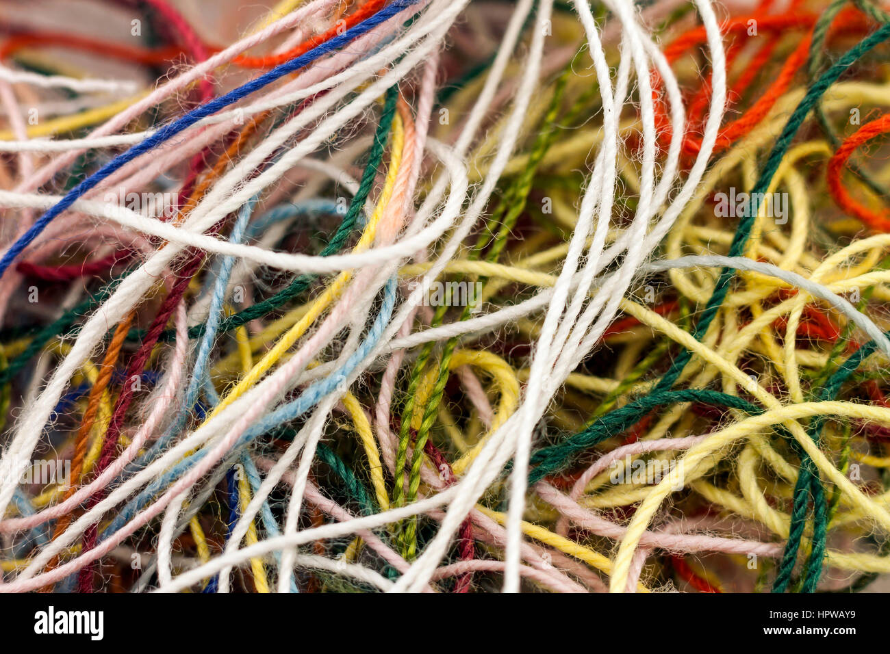 Multi-colored tangled colorful needlecraft silk thread rope. Macro shot ...