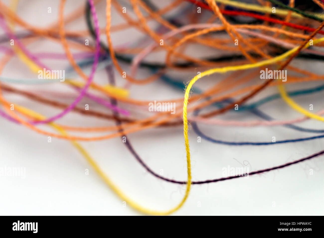 Multi-colored tangled colorful needlecraft silk thread rope. Macro shot ...