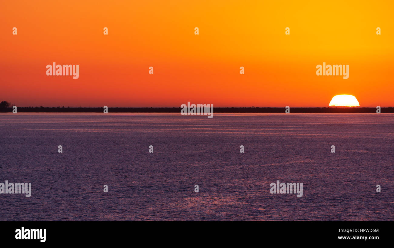 Colorful Tampa Bay sunset with sun halfway set below the horizon Stock ...