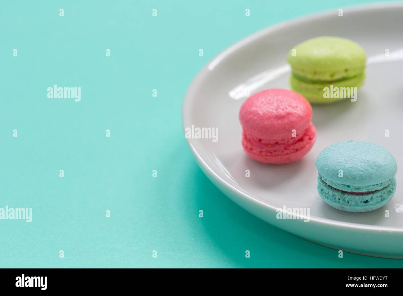 A colorful macaron- french dessert ,closeup and focused blue macaron ...