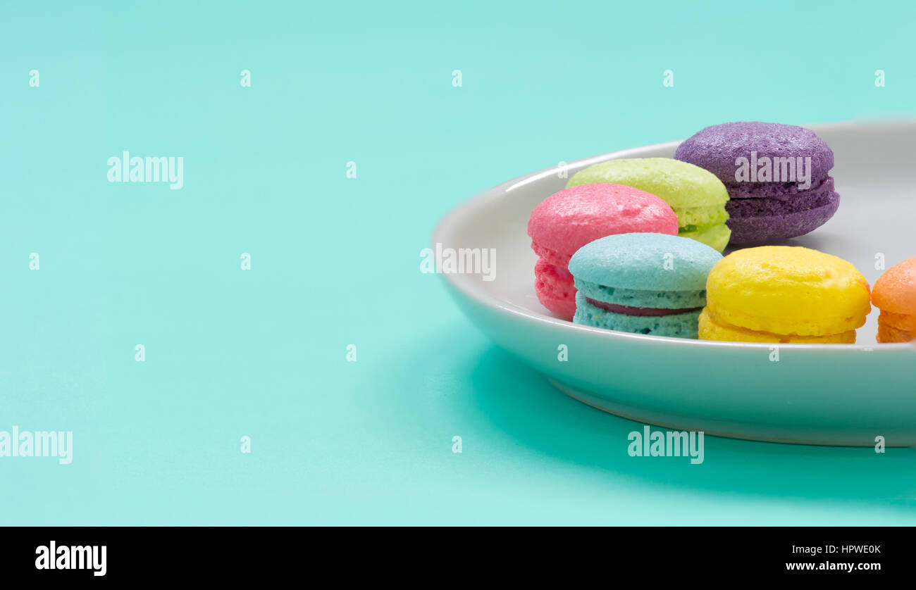 A colorful macaron- french dessert ,closeup and focused blue macaron ...