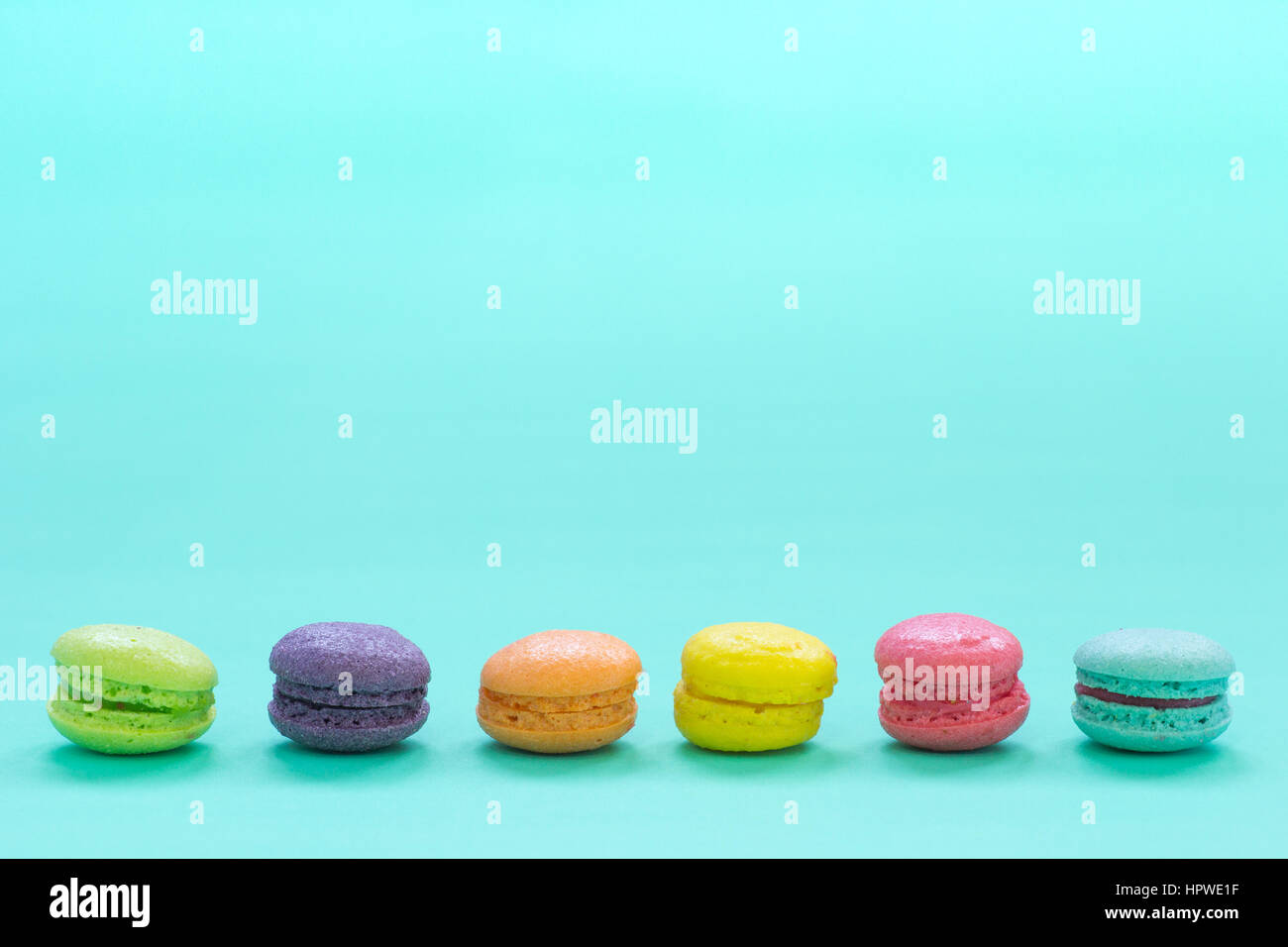 A colorful macaron- french dessert ,closeup and focused blue macaron ...