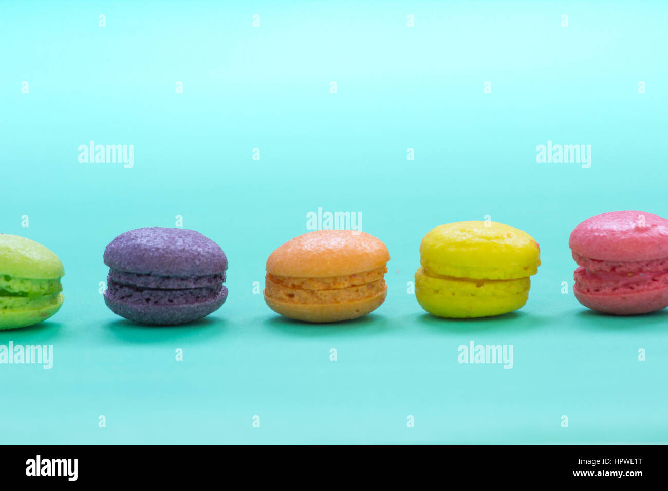 A colorful macaron- french dessert ,closeup and focused blue macaron ...