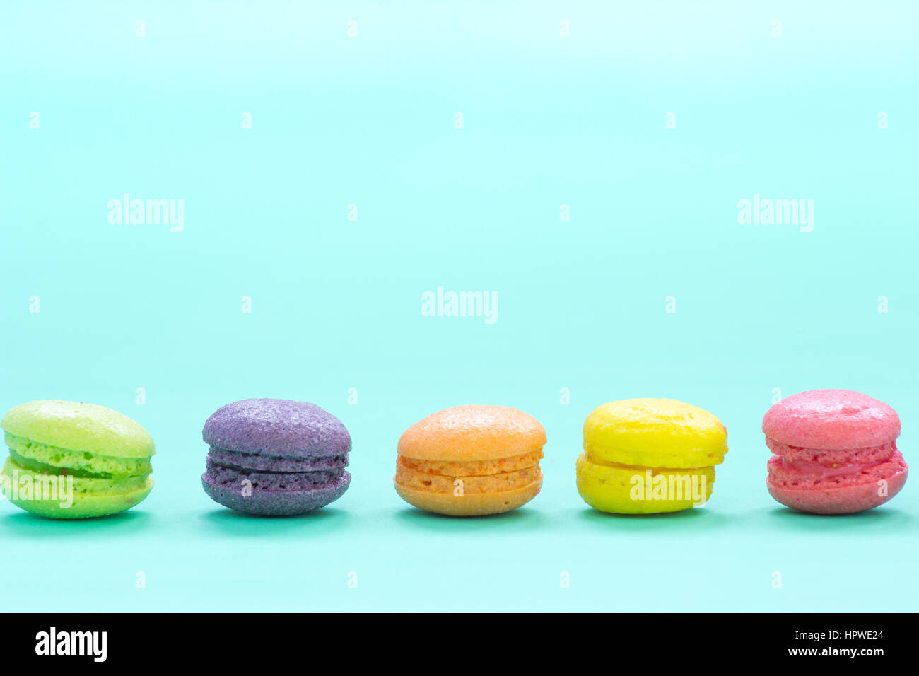 A colorful macaron- french dessert ,closeup and focused blue macaron ...