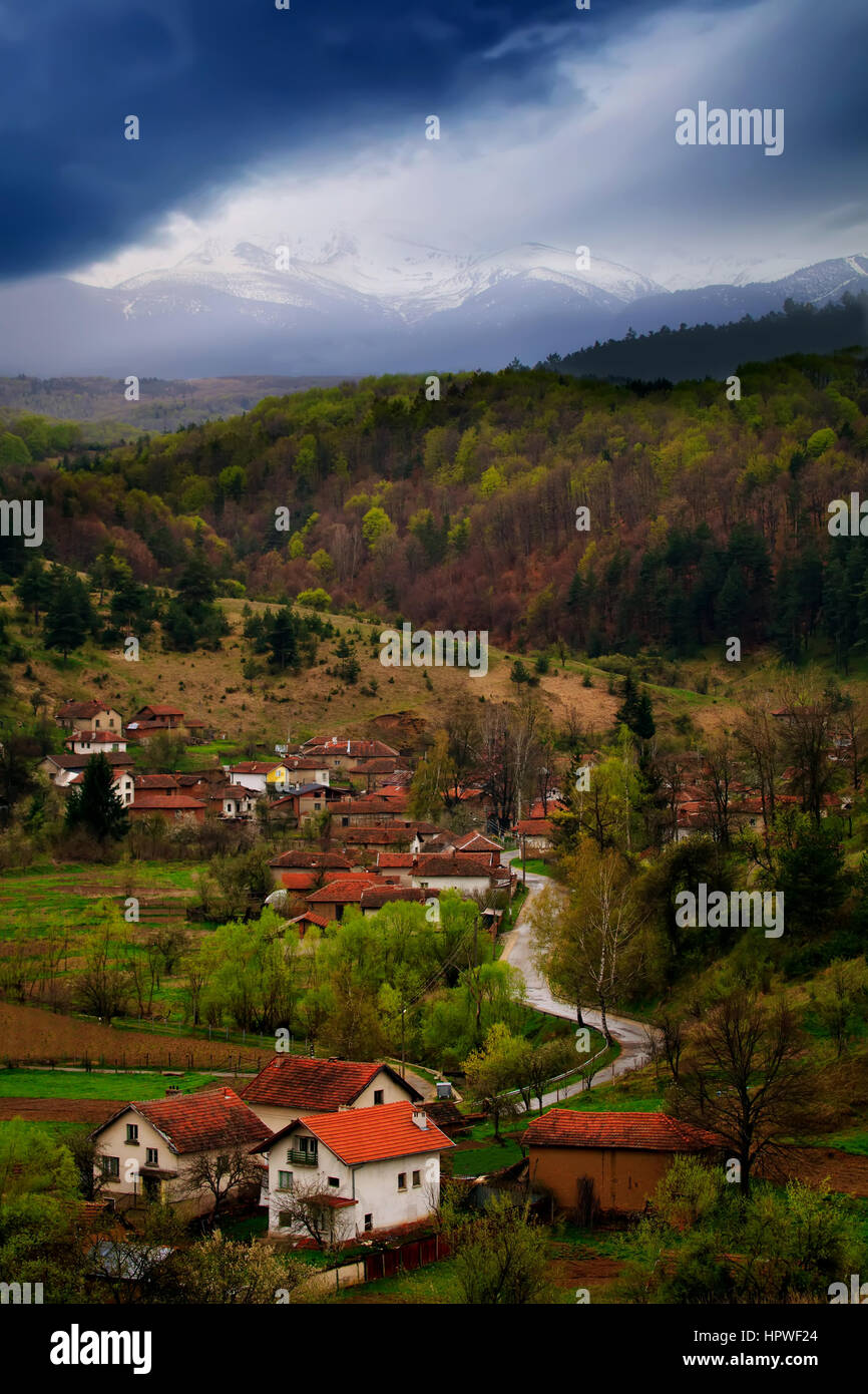 vertical landscape with small bulgarian village in Rila mountains ...